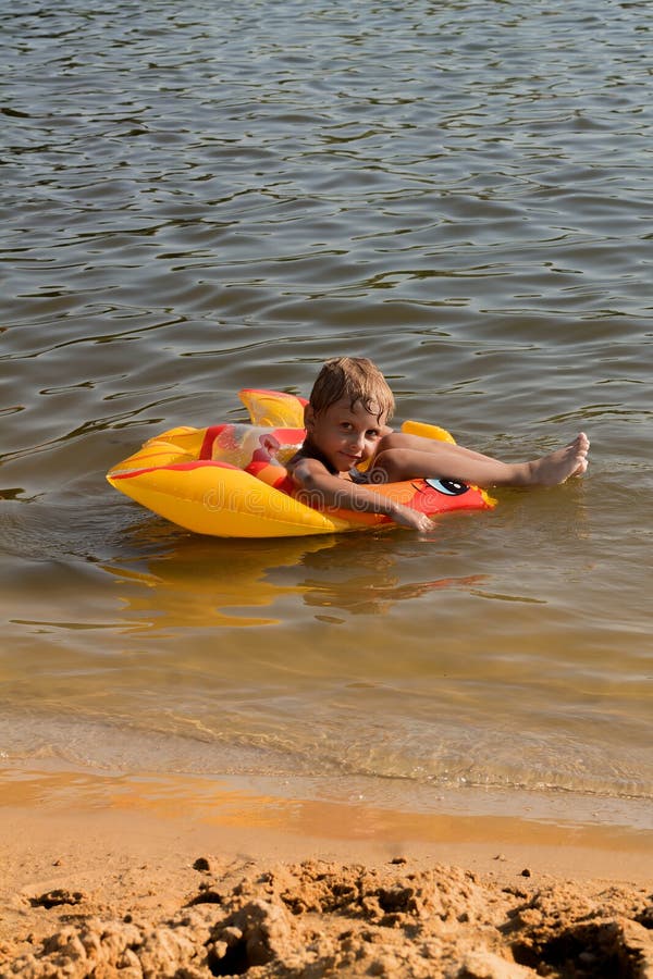 A Boy Floats on an Inflatable Circle Stock Photo - Image of ring ...