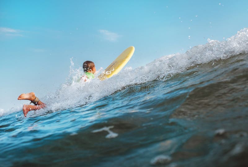 Boy Floats on Surf Board Over the Wave Crest Stock Image - Image of ...
