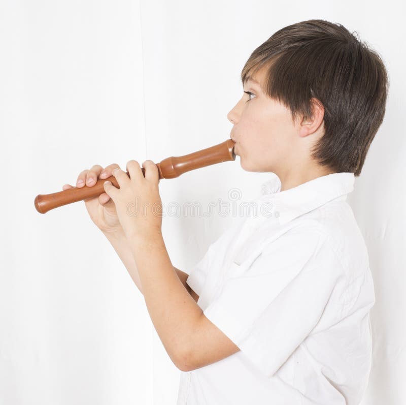 Child playing a recorder stock image. Image of childhood - 1253665