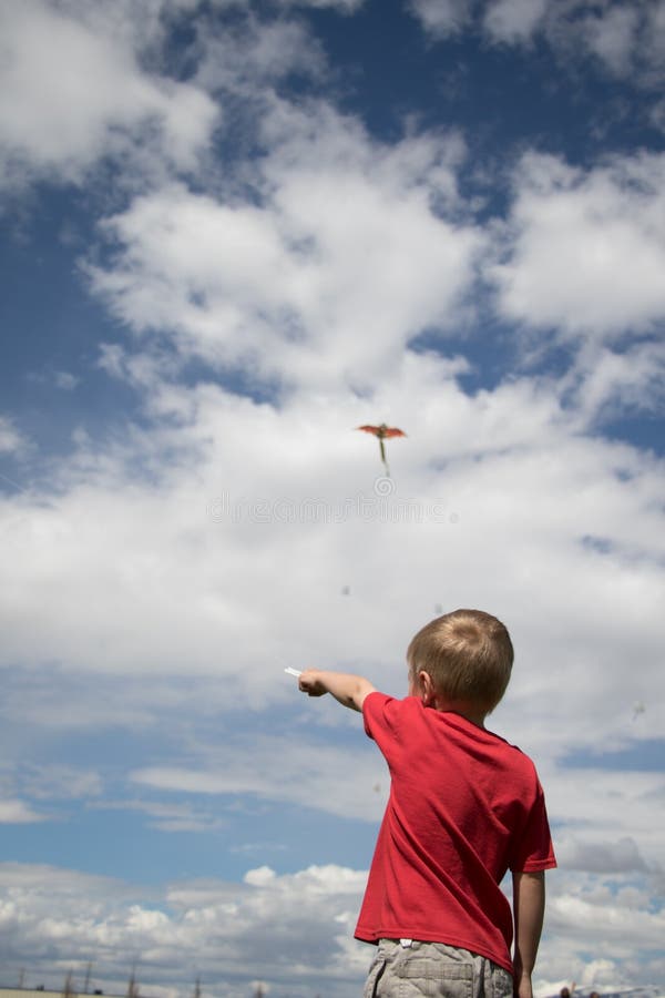 Boy Flying Kite with Cloudy Sky Stock Photo - Image of kite, cloud ...