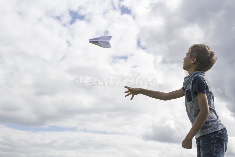 Boy Flying a Paper Plane Against Blue Sky Stock Image - Image of person ...