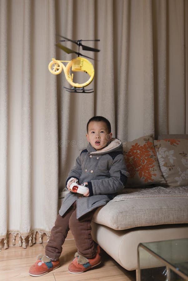 Boy flying toy helicopter stock photo. Image of seat - 49216488