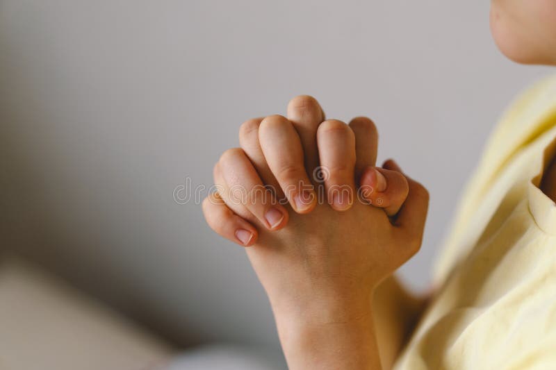 A Boy with Folded Hands in Front of Him, he Prays in His Room. Stock ...