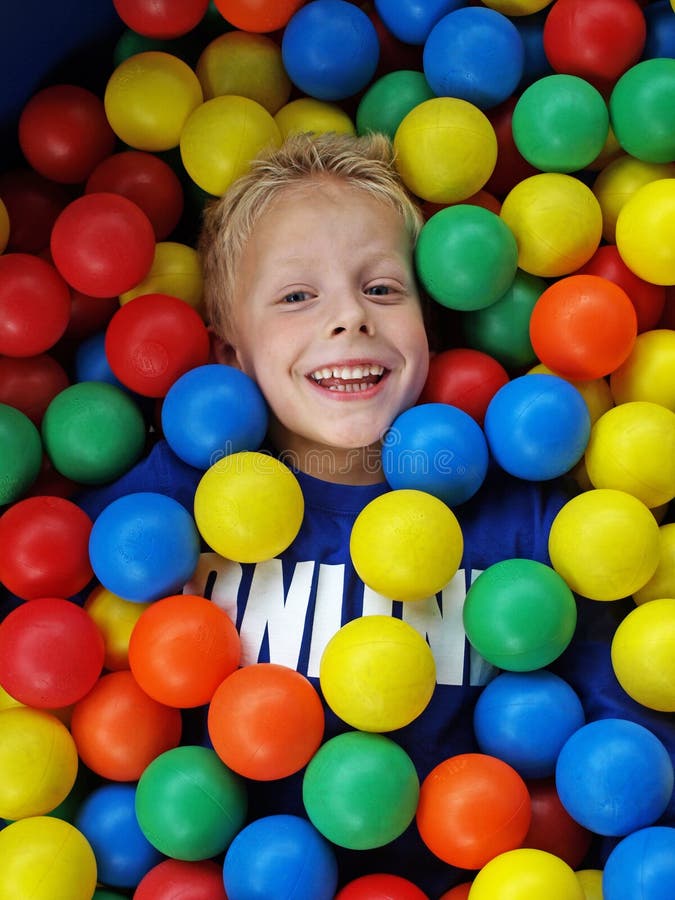 Boy in fun balls stock photo. Image of green, colour - 21453504