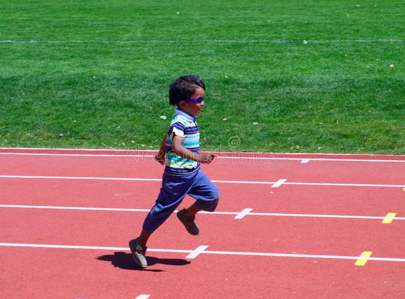 Boy running at track meet stock image. Image of blond - 13191095