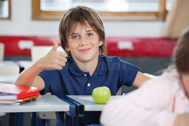 Boy Gesturing Thumbs Up in Classroom Stock Photo - Image of elementary ...
