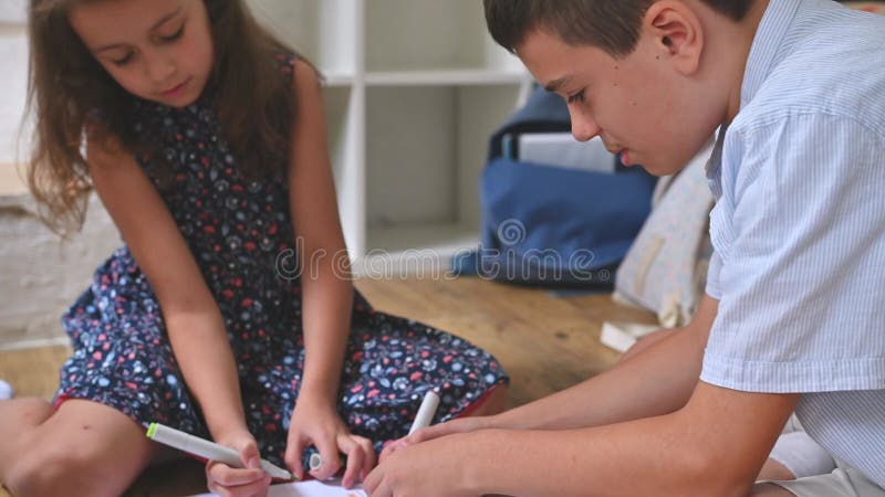 Children Focused on Drawing Together, a Boy and Girl Using Markers ...