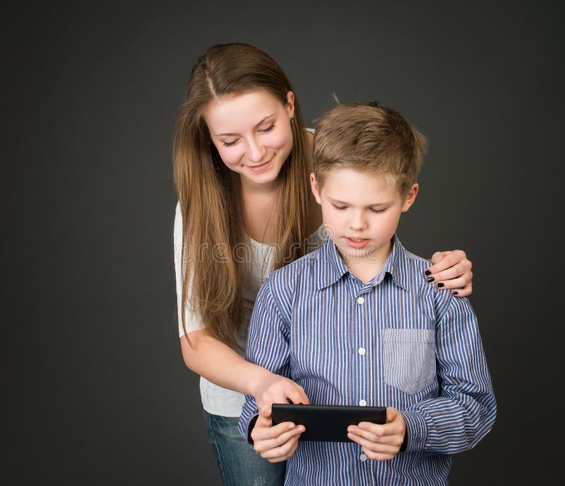 Boy and Girl with Digital Tablet. Interested in Technology Stock Photo ...