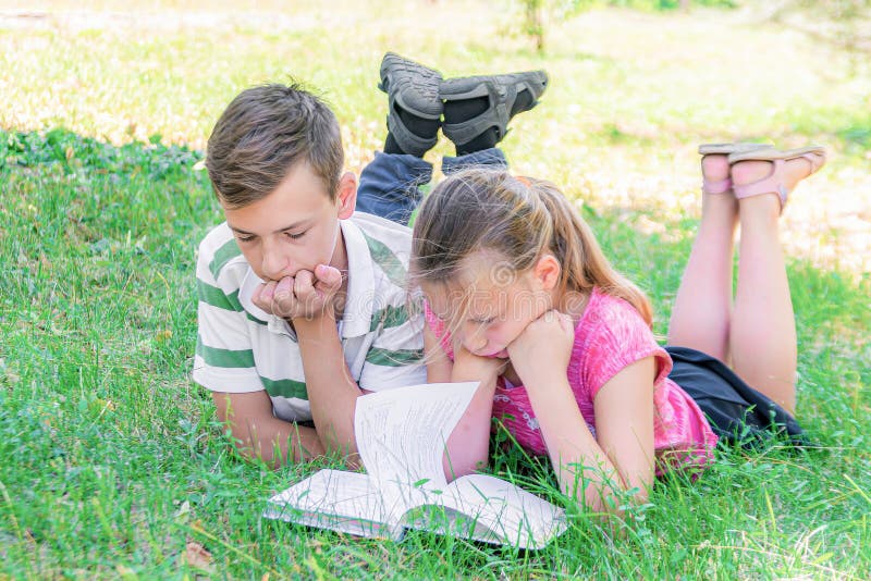 Boy with a Girl Doing Homework on the Grass in the Park Stock Image ...