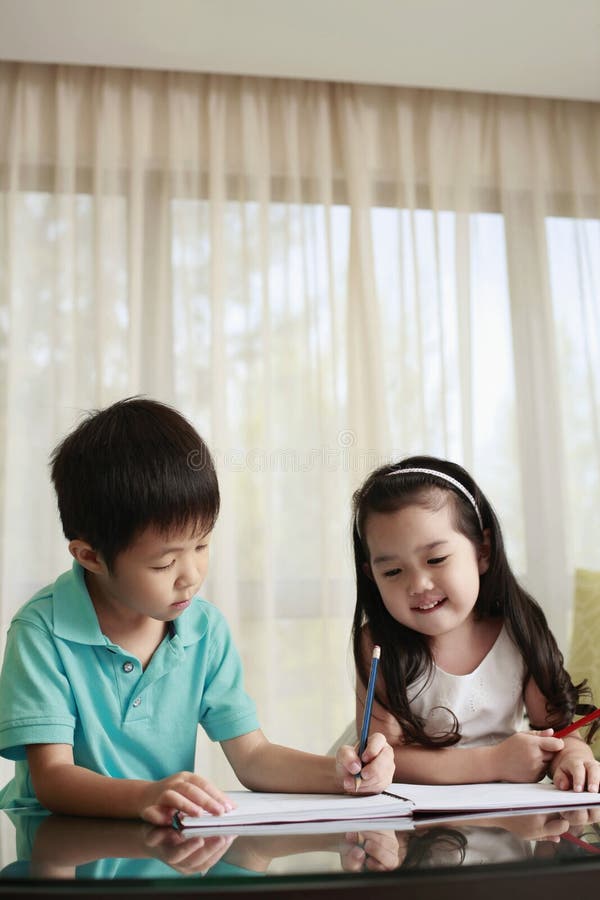 Boy and Girl Doing Homework Together. Conceptual Image Stock Image ...