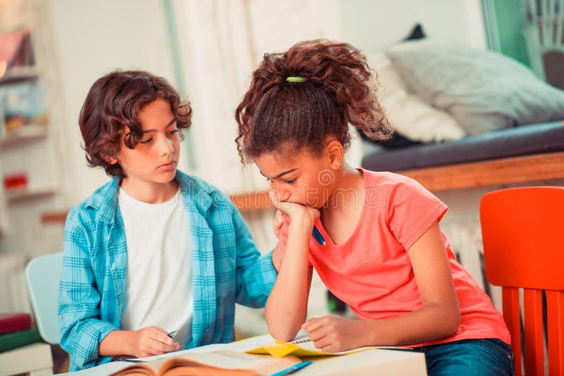 A Boy and a Girl Doing Their Home Task Together Stock Photo - Image of ...