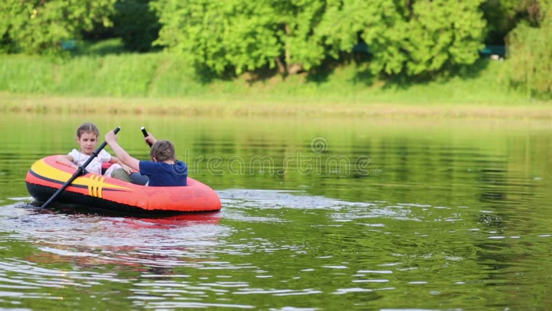Boy and Girl Float in Inflatable Boat with Oars Stock Footage - Video ...