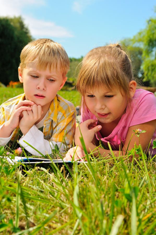 Boy and Girl are Reading a Book Stock Photo - Image of action, handsome ...