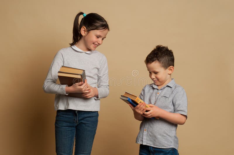 Boy and Girl Reading a Book in Studio. Studying and Education Stock ...