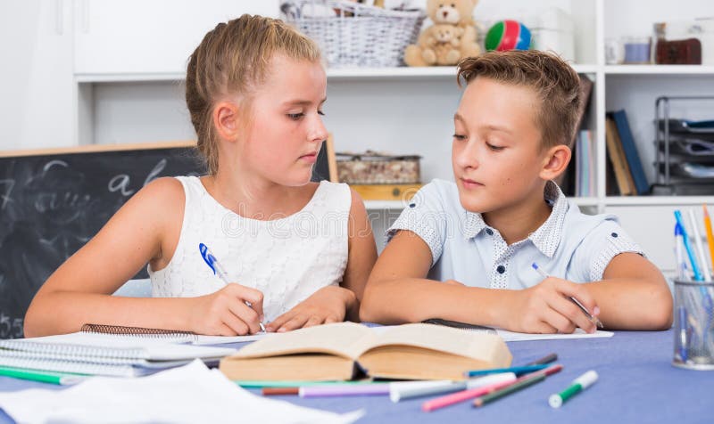 Boy with Girl are Writing in Notebook Their Homework Stock Image ...