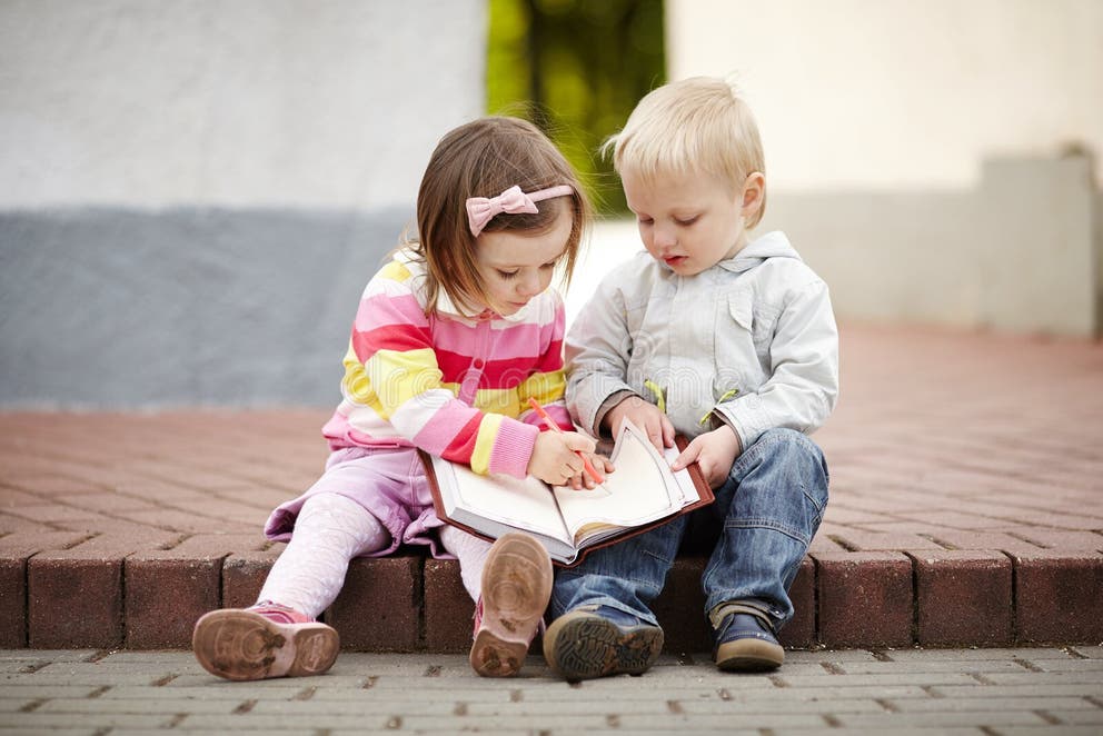 Boy and Girl Writing To Notebook Stock Photo - Image of female, outdoor ...