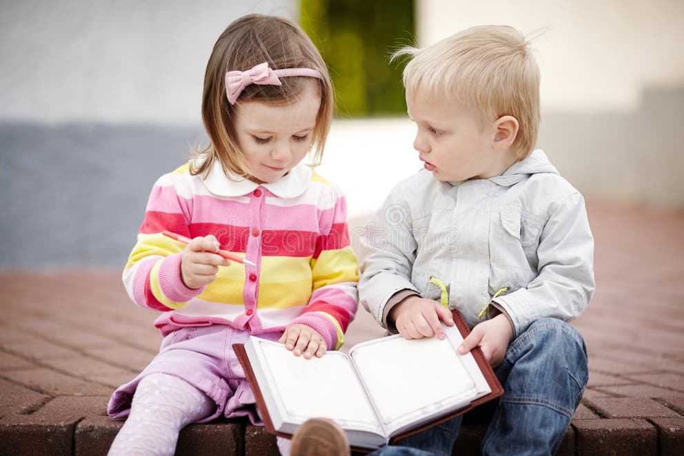 Boy and Girl Writing To Notebook Stock Photo - Image of outdoors ...