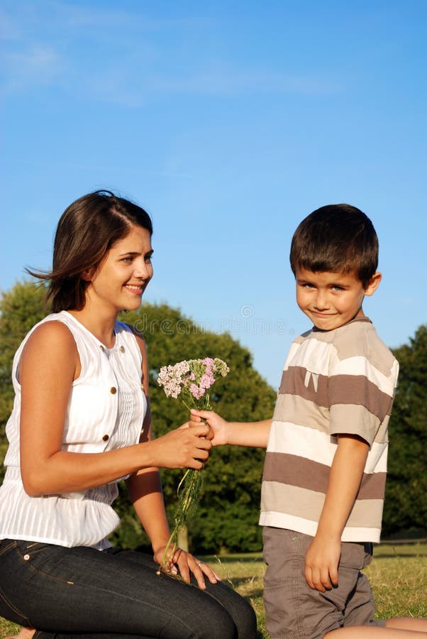 Little Boy Giving Flower To His Mom Stock Image - Image of family ...