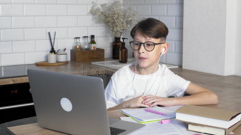 A Boy with Glasses and Headphones in an Online Lesson. Distance ...