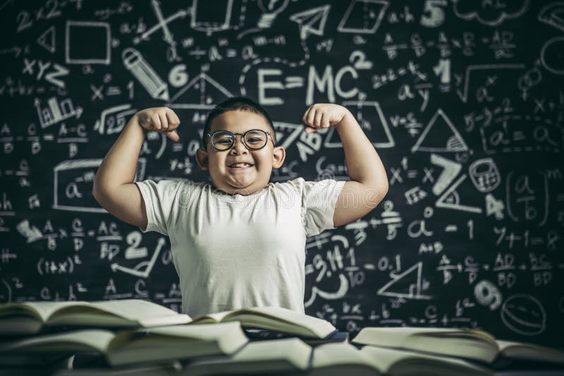 A Boy with Glasses Sitting in the Study and with Both Arms ...
