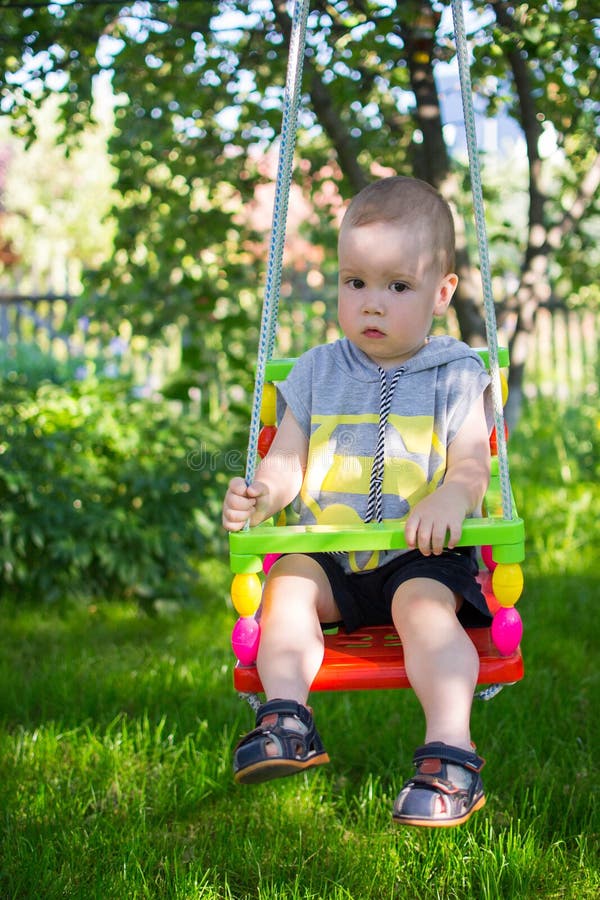 Boy Goes for a Drive on Swing Stock Photo - Image of young, cute: 75230986