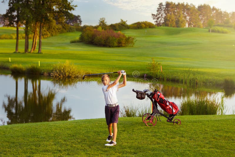 Boy playing golf stock photo. Image of player, evening - 104134380