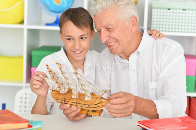 Boy with Model of Ship and Handsaw Stock Photo - Image of face, massive ...