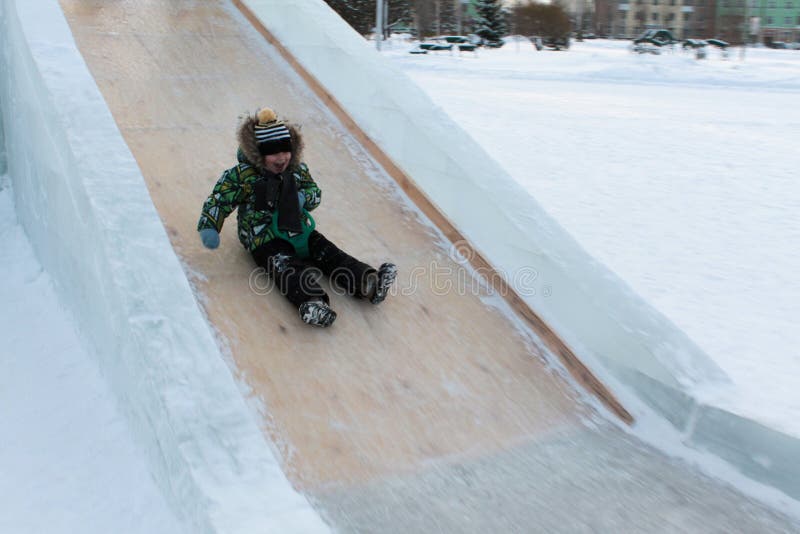 The Boy Slides on the Ice Slide Stock Image - Image of healthy, happy ...