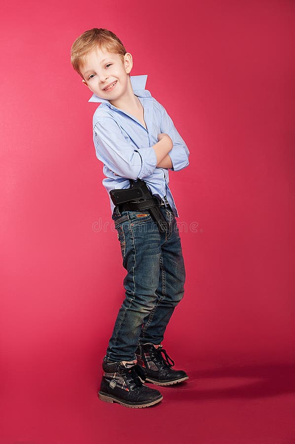 A Little Boy is Silling on a Trunk Stock Photo - Image of vertical ...