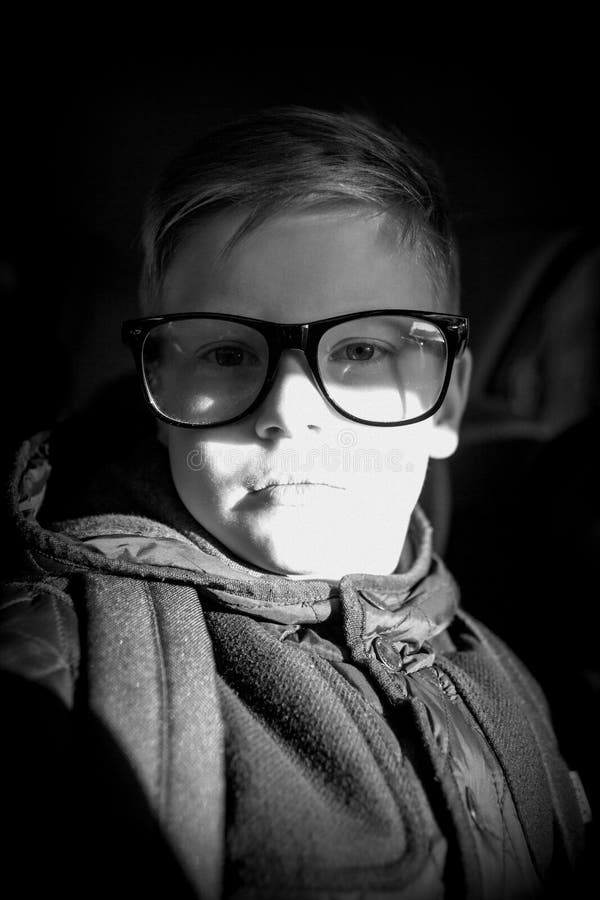 A Boy with Half-lighted Face Looking To the Camera. Boy`s Face in the ...