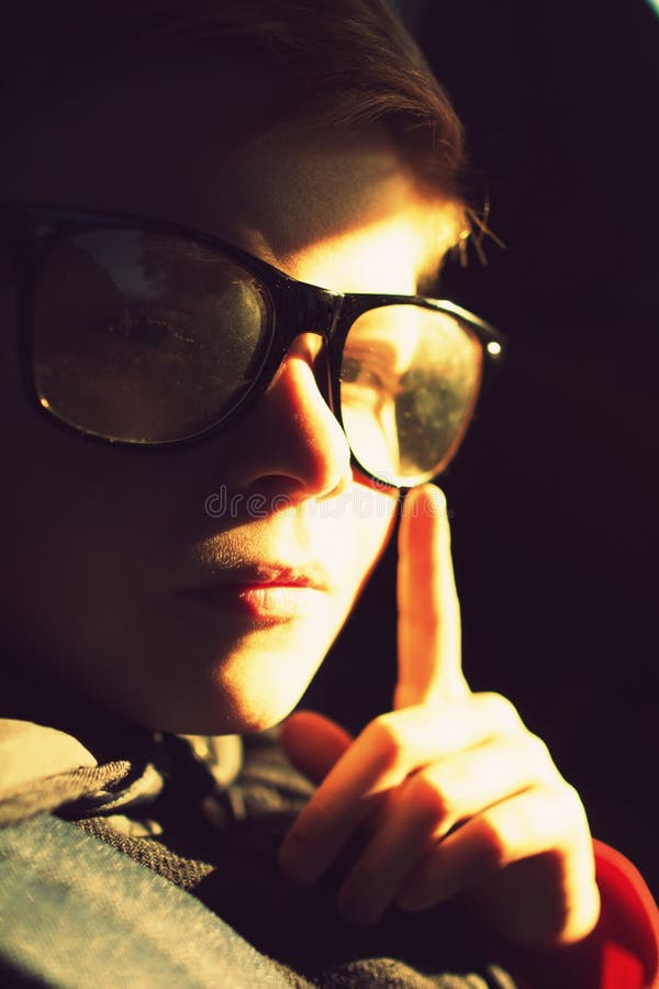 A Boy with Half-lighted Face Looking To the Camera. Boy`s Face in the ...