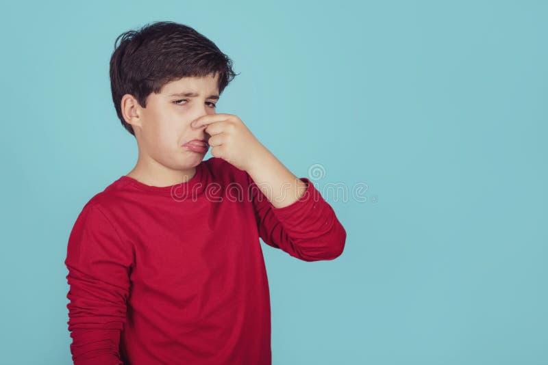Boy with hand in nose stock photo. Image of reaction - 117132766
