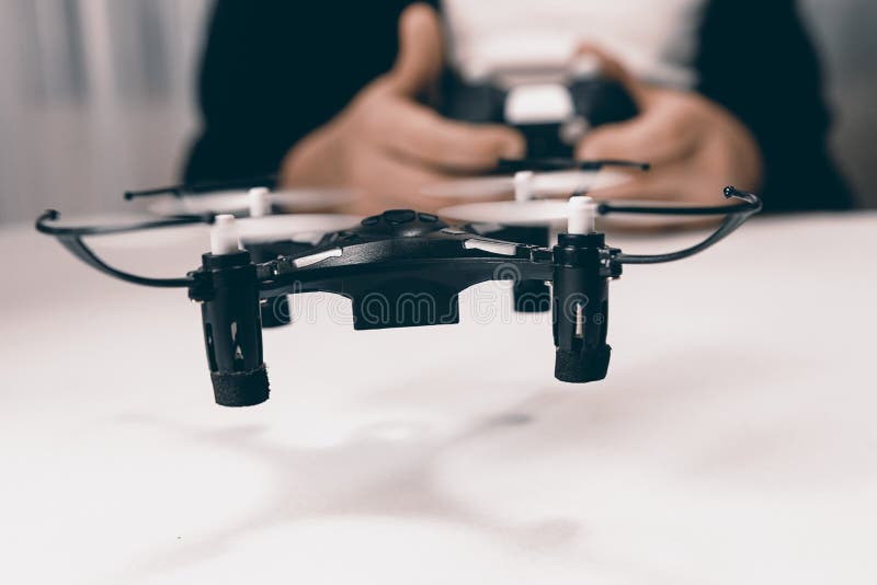 Boy Hands with a Remote Control Flying a Small Drone Toy Indoors Stock ...