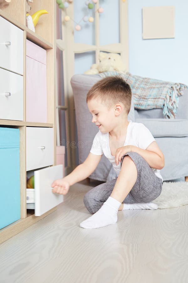 Boy in the Hands Sat on the Floor Near the Wardrobe Stock Image - Image ... Boy in the Hands Sat on the Floor Near the Wardrobe Stock Image - Image ...