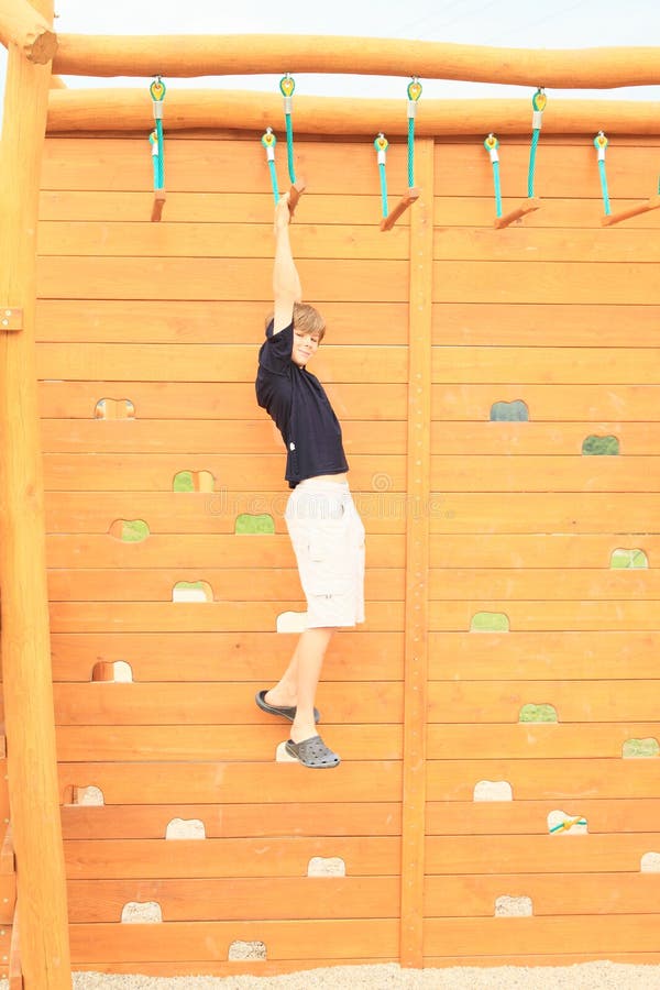Boy Hanging on Obstacle Course Stock Photo - Image of hang, wooden ...
