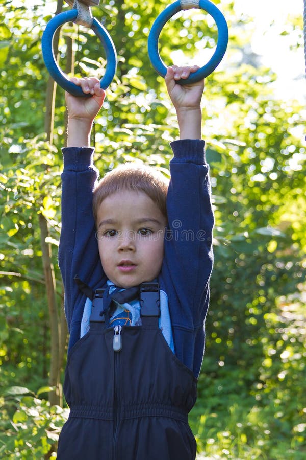 Boy hanging on the rings stock image. Image of healthy - 32614059