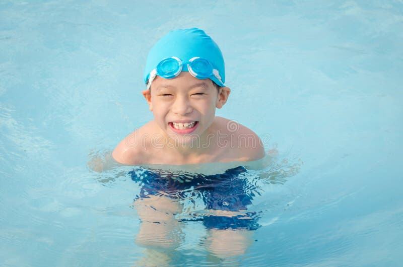 Boy happy at swimming pool stock photo. Image of holiday - 68299538