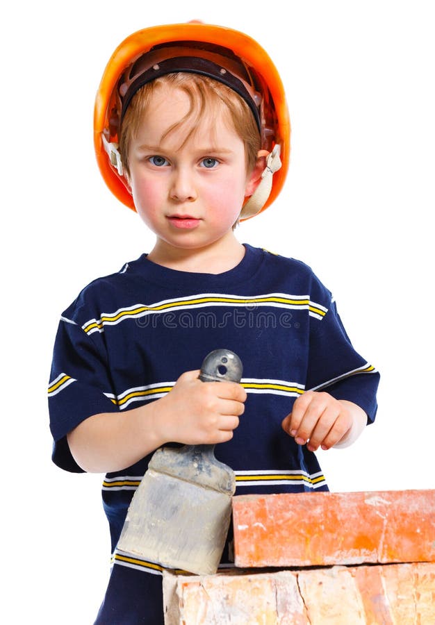Boy in hard hat with brick stock image. Image of builder - 25189117
