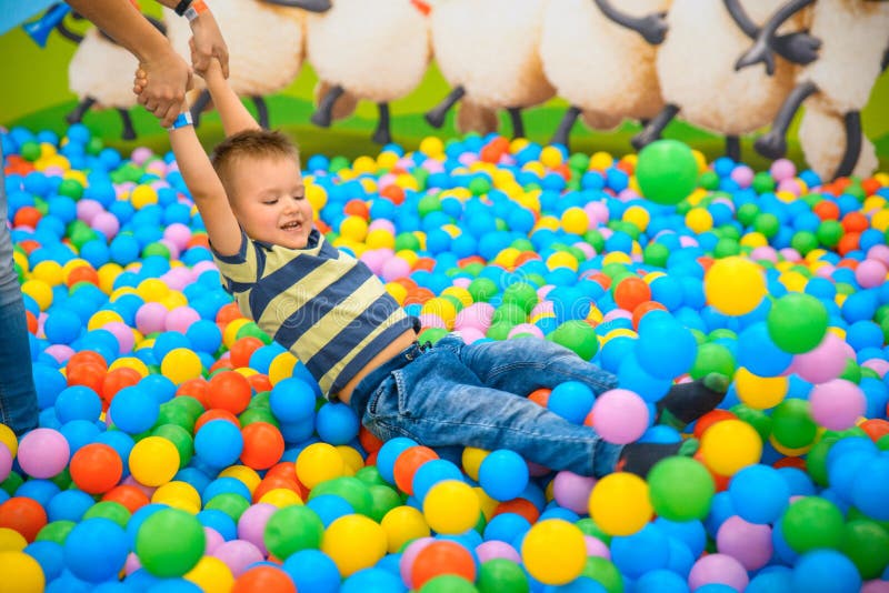 A Boy with Mother in the Playing Room with Many Little Colored Balls ...