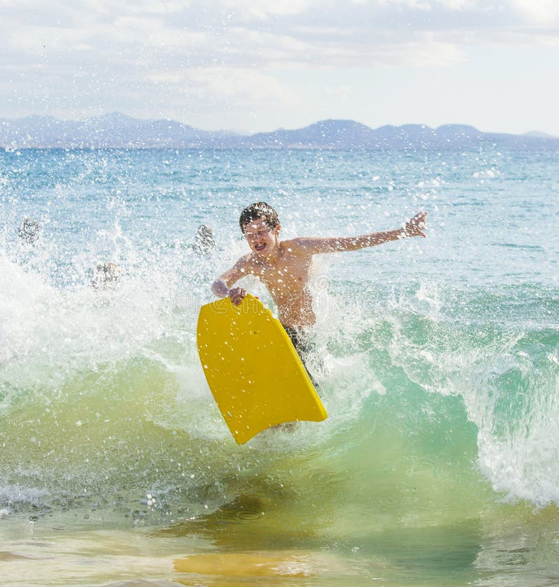 Boy Has Fun in the Ocean with His Boogie Board Stock Image - Image of ...