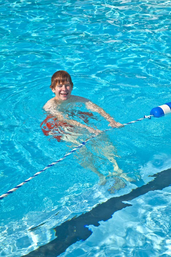 Boy has fun in the pool stock image. Image of attractive - 36061891