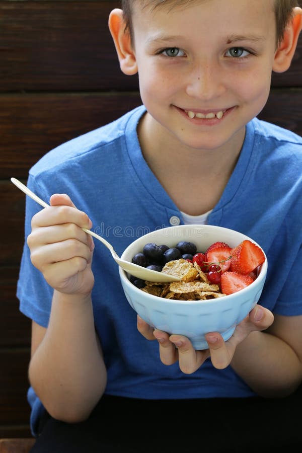 The Boy Has a Healthy Breakfast of Cottage Cheese and Granola Stock ...