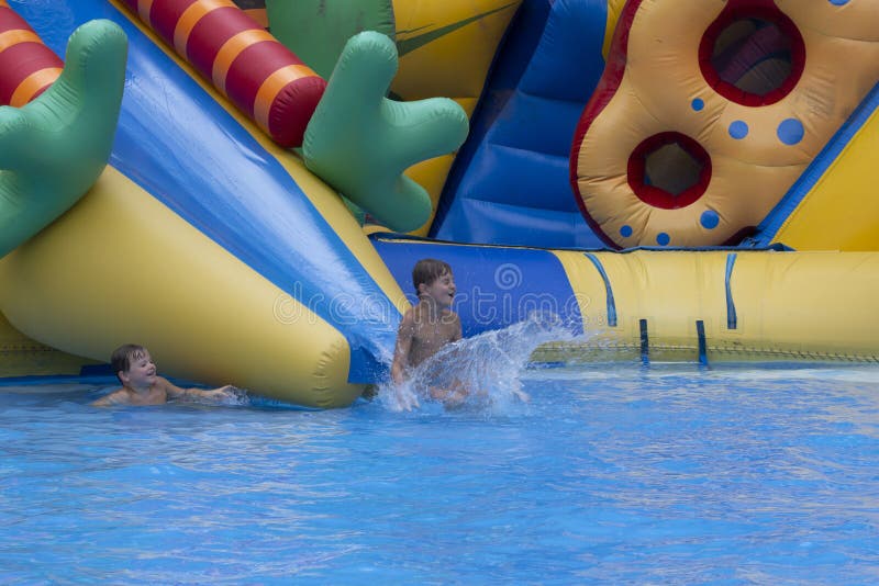 Boy Has into Pool after Going Down Water Slide during Summer. Little ...
