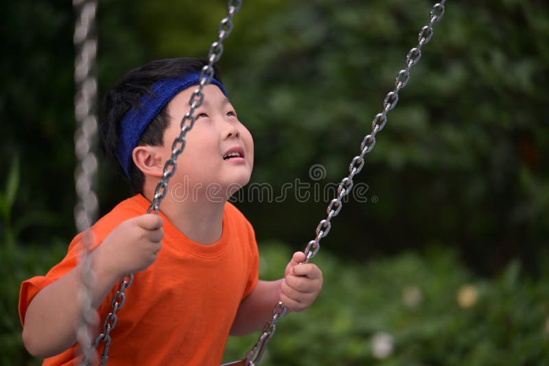Boy have a ride on a swing stock photo. Image of spring - 279333090