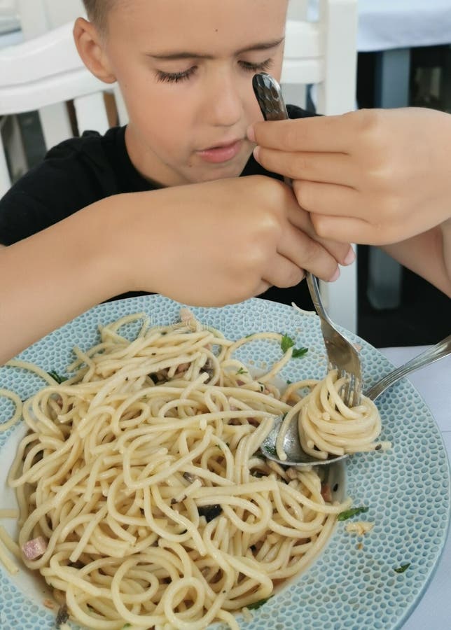 Boy having dinner stock image. Image of spaghetti, produce - 183570945