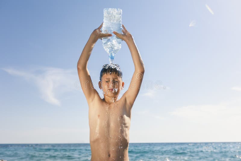 Boy is Having Fun on the Beach, Getting Splashed with Water Stock Image ...