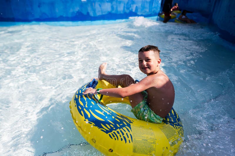Boy Having Fun in an Inflatable Ring in a Swimming Pool Stock Photo ...