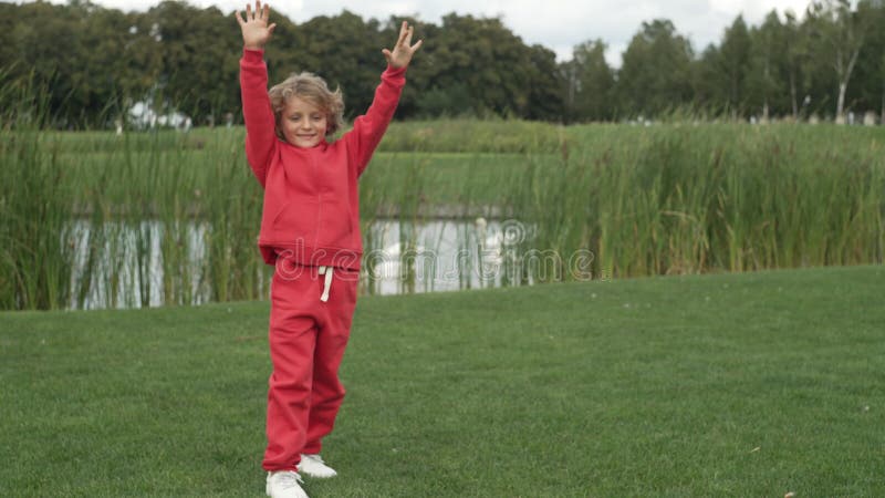 The Boy is Having Fun in the Park on the Grass. a Happy Smiling Child ...