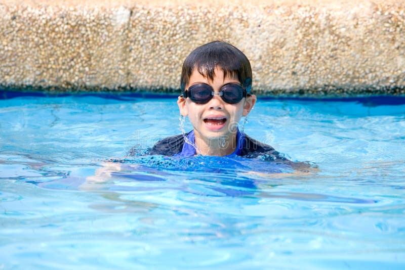 Boy having fun in the pool stock photo. Image of develop - 5295156