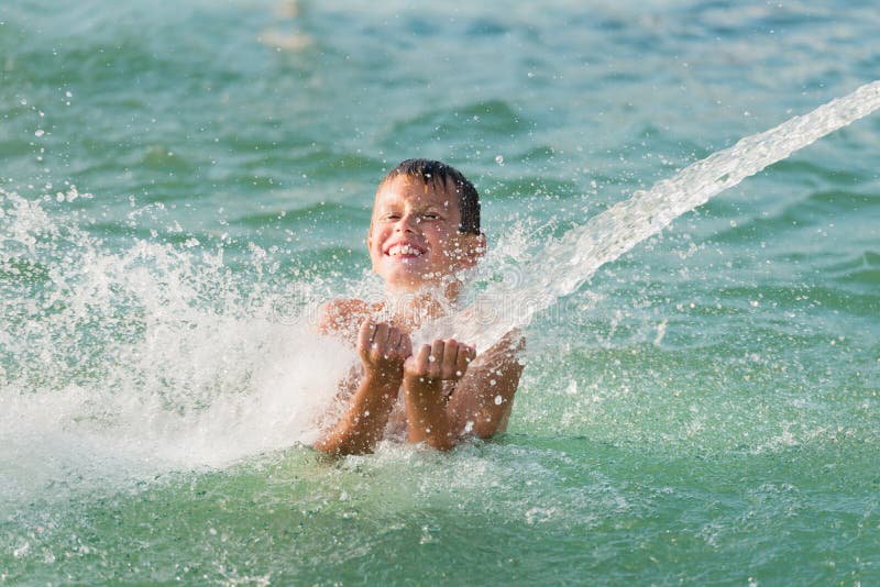 Boy having fun in water stock image. Image of holidays - 32835925